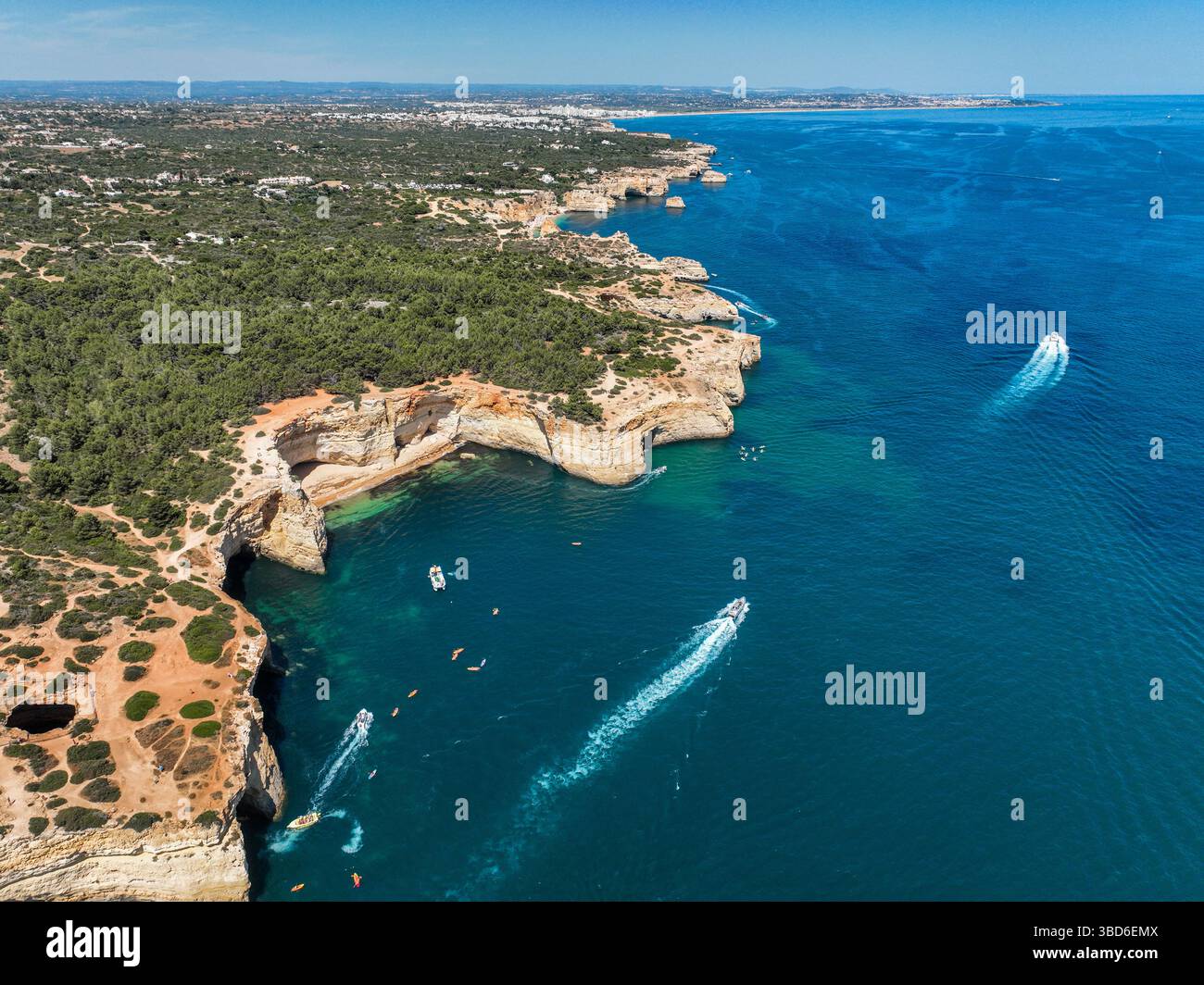 Steep coastal cliffs and deep blue ocean viewed from above in Algarve ...