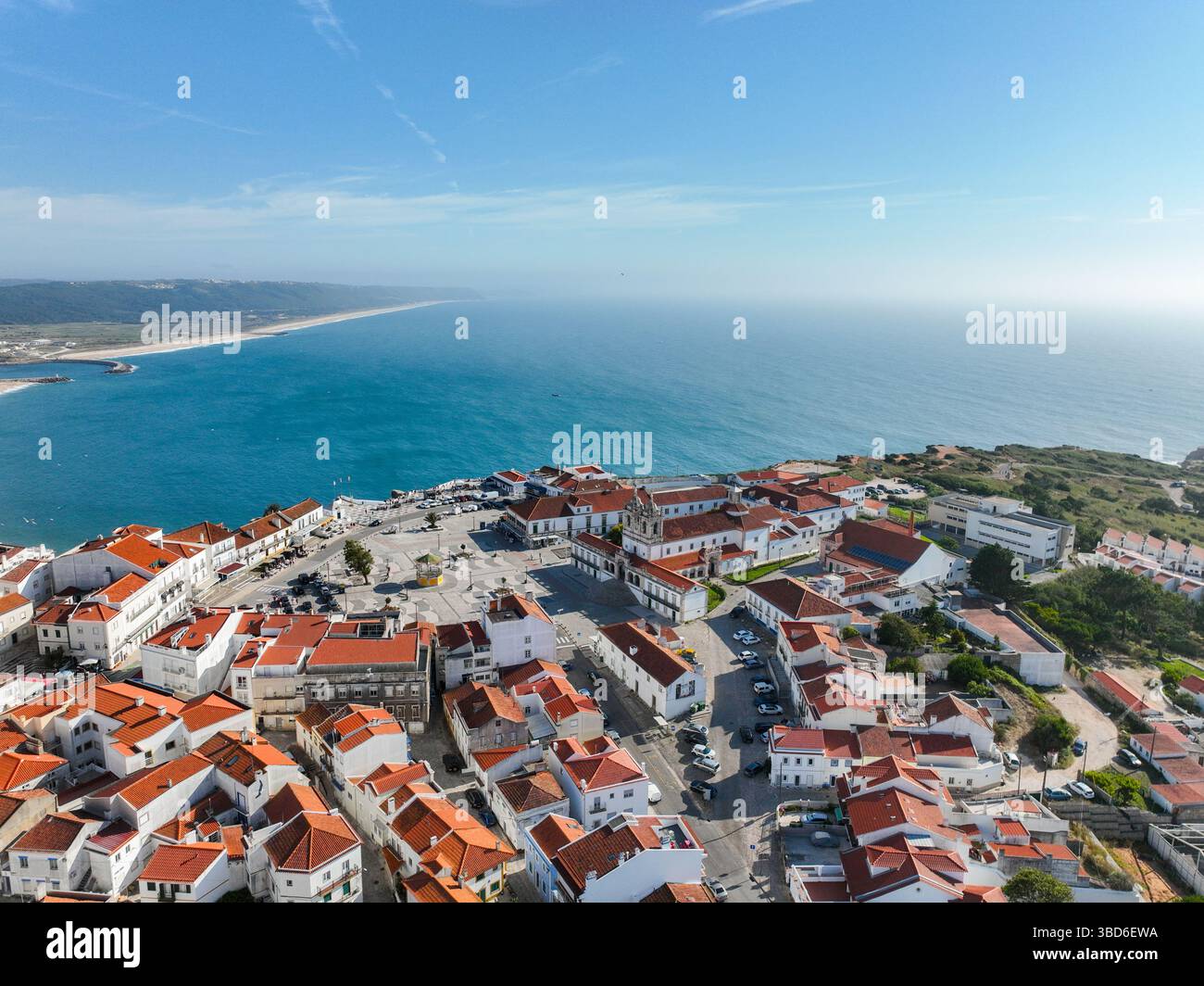 Aerial view of Nazare showing the town square, church, and Praia da ...