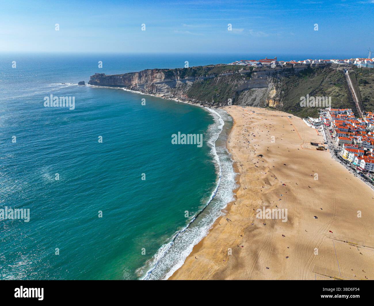 Aerial view of Nazare's expansive beach, port, and Atlantic horizon ...