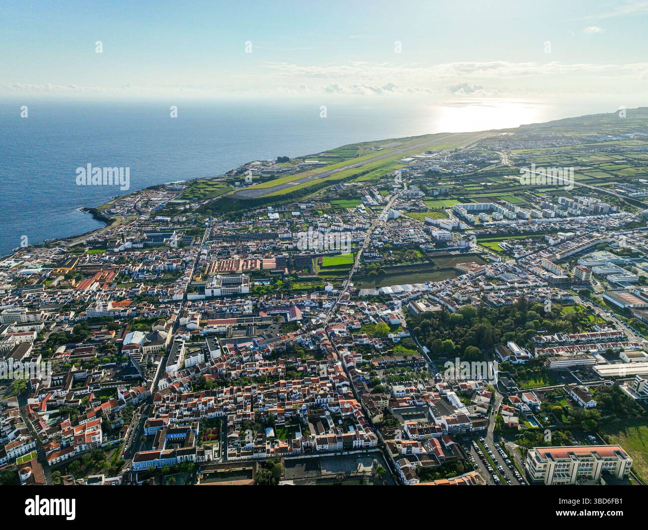 Aerial view of Ponta Delgada urban layout near coast, airport runway ...