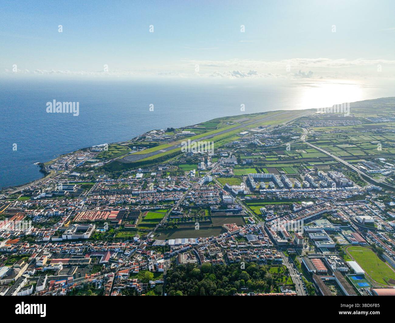 Aerial view of Ponta Delgada urban layout near coast, airport runway ...