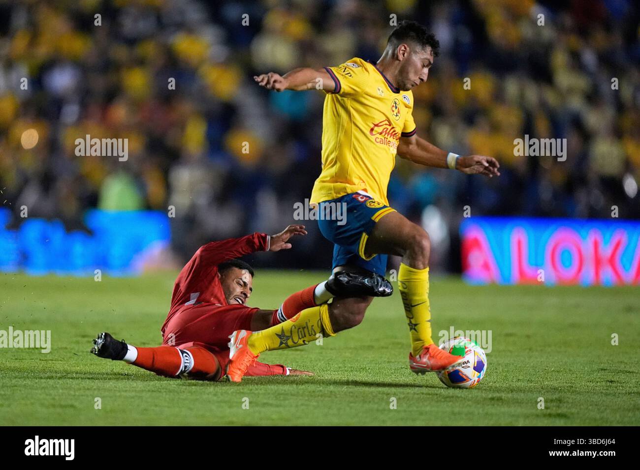Toluca's Alexis Vega, left, tackles America's Sebastian Caceres during ...