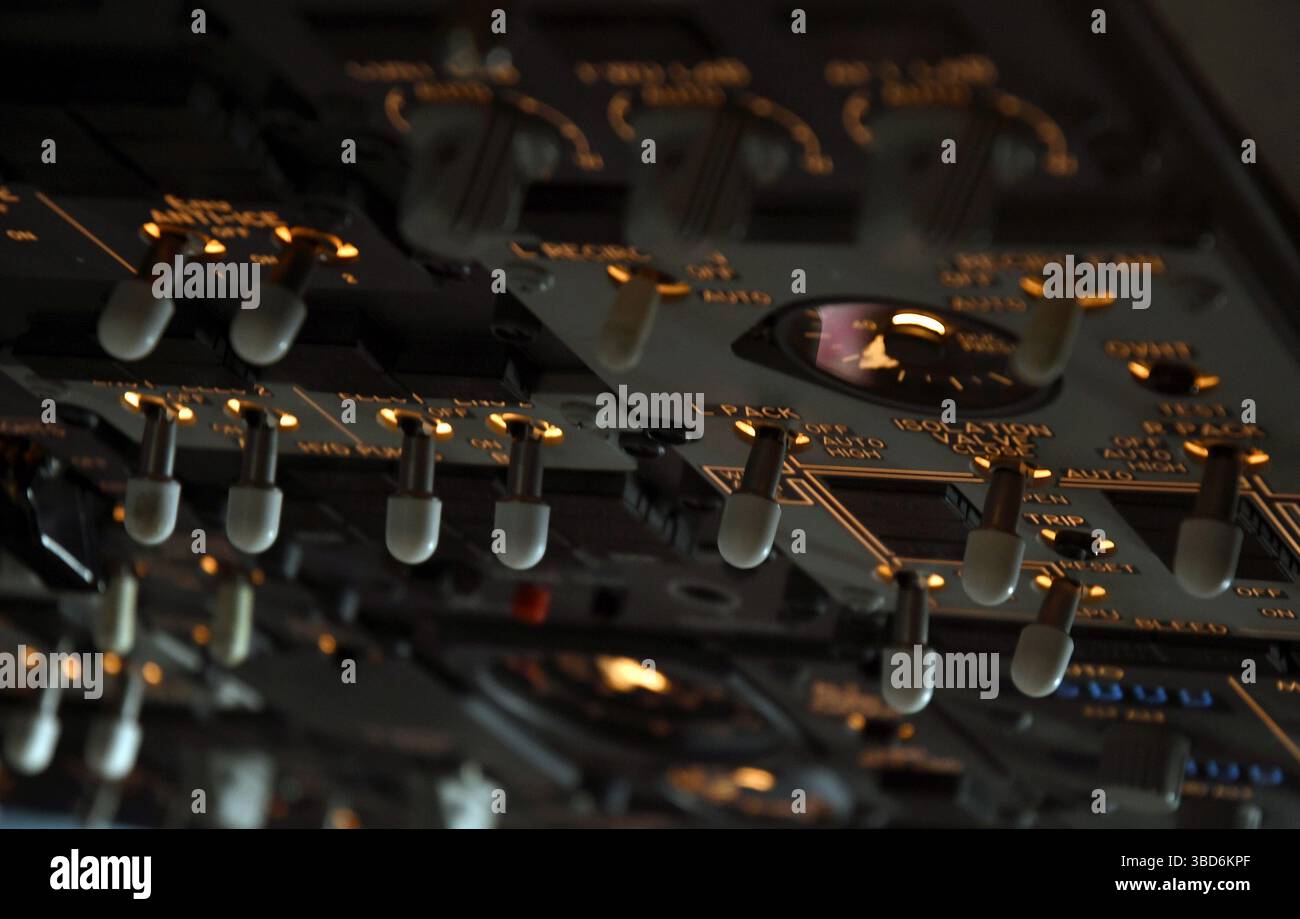 Switches in the cockpit of a United Airlines flight simulator are lit ...