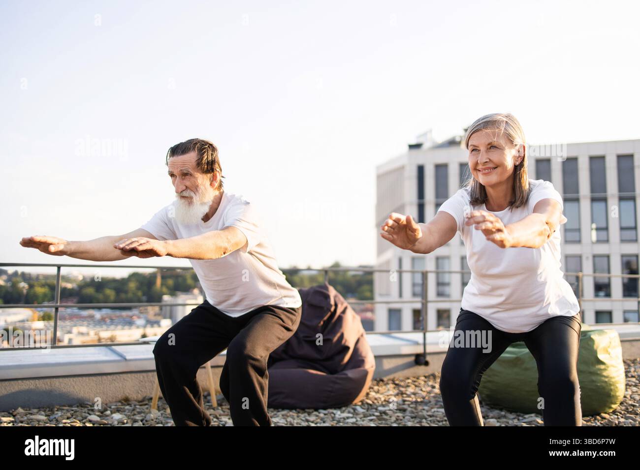 Couple doing exercises on terrace hi-res stock photography and images ...