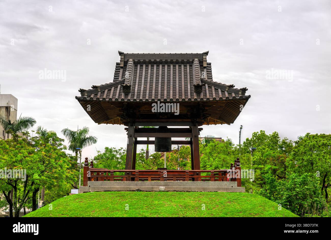 Traditional wooden bell tower structure with ornate tiled roof ...