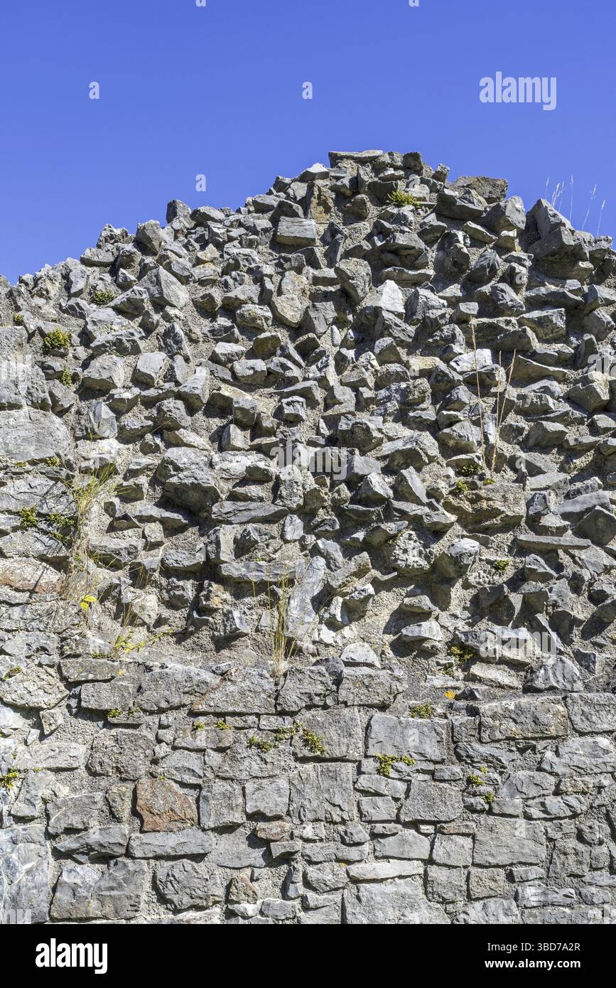 Thick stone wall of medieval castle showing two types of masonry ...