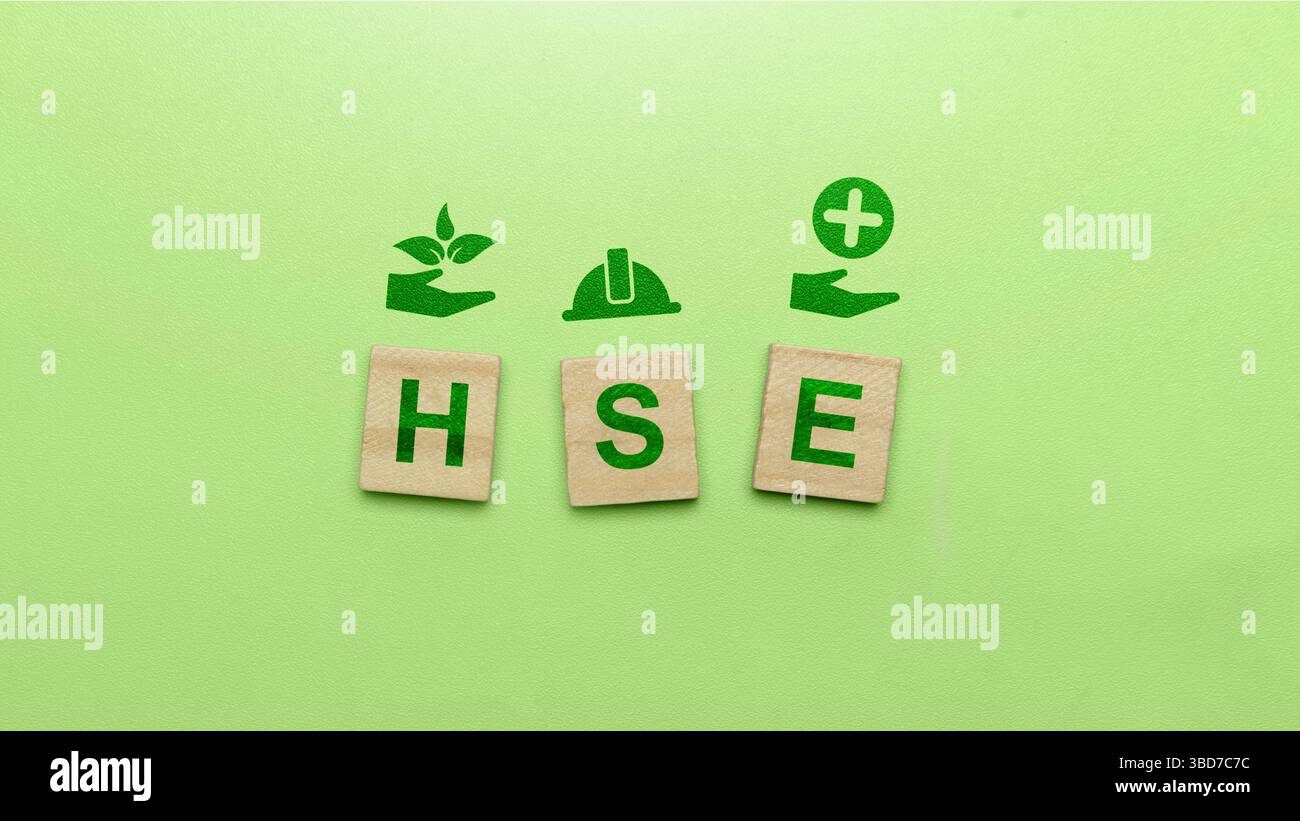 Wooden cubes with HSE sign on green background. Abbreviation of Health ...