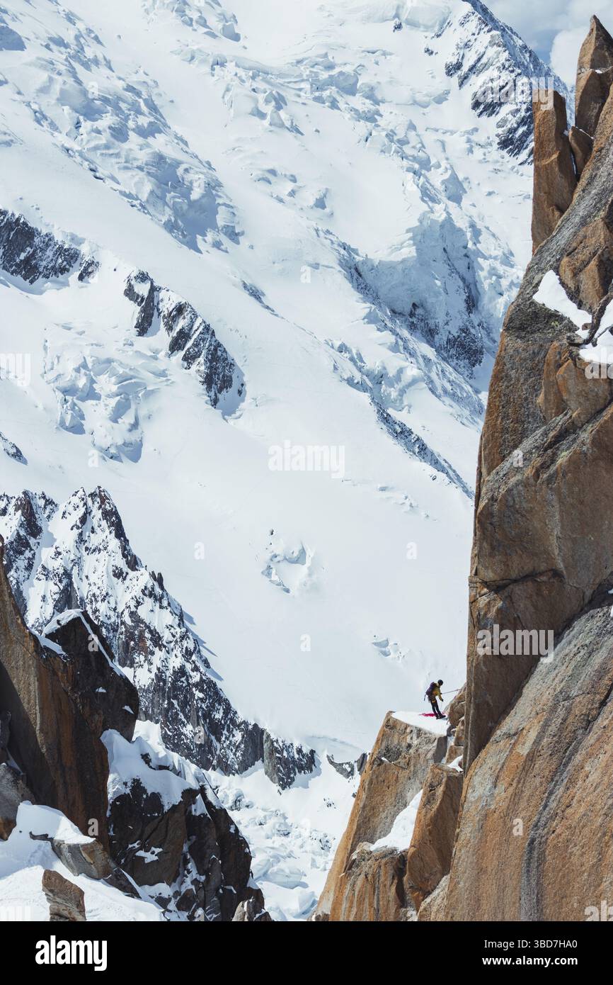 A rock climber with ropes on a crag in the Mont Blanc massif above the ...