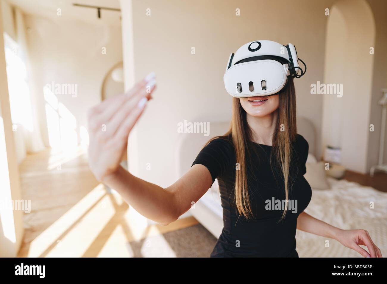 Woman explores virtual reality in modern interior during daylight hours ...