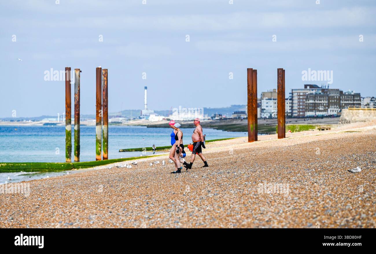 Early morning sea swimmers off Brighton beach May 2025 Stock Photo - Alamy