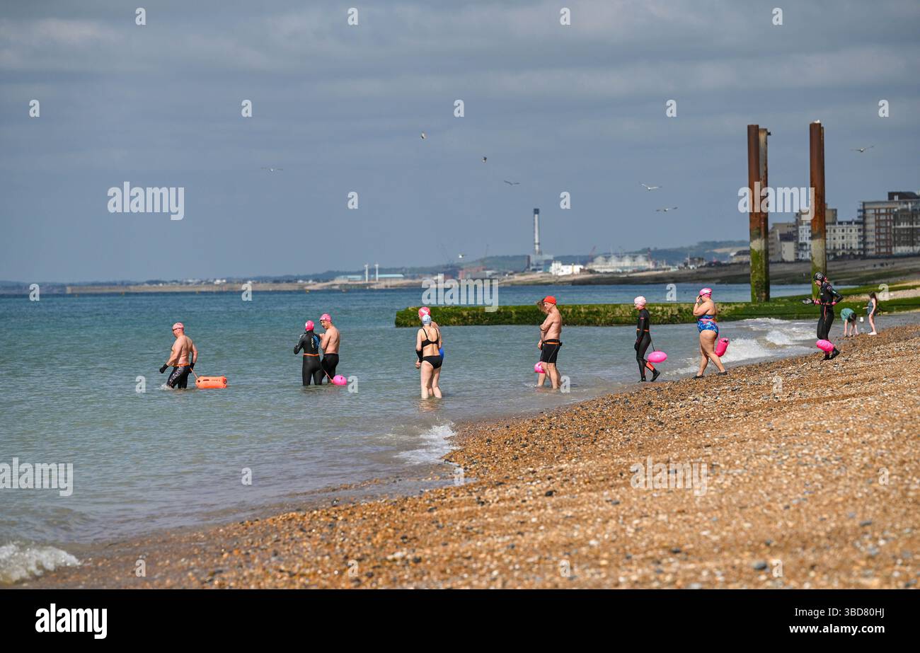 Early morning sea swimmers off Brighton beach May 2025 Stock Photo - Alamy