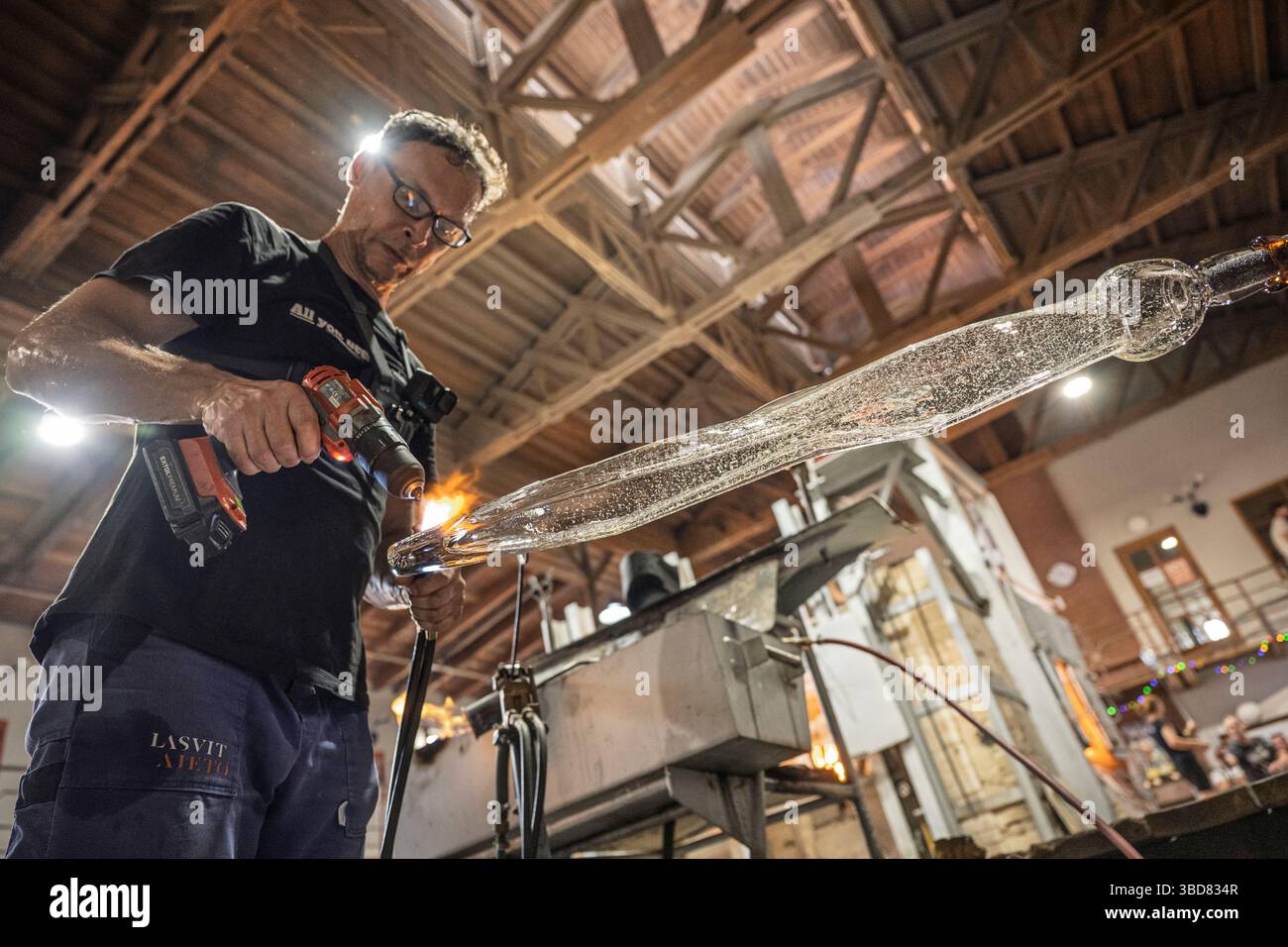 Glassmakers creating decorative approximately meter-long crystals for ...