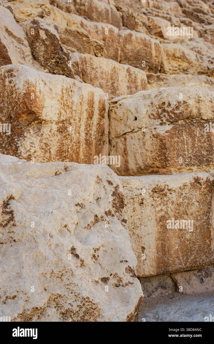 Large ancient limestone blocks form the base of a historical structure ...