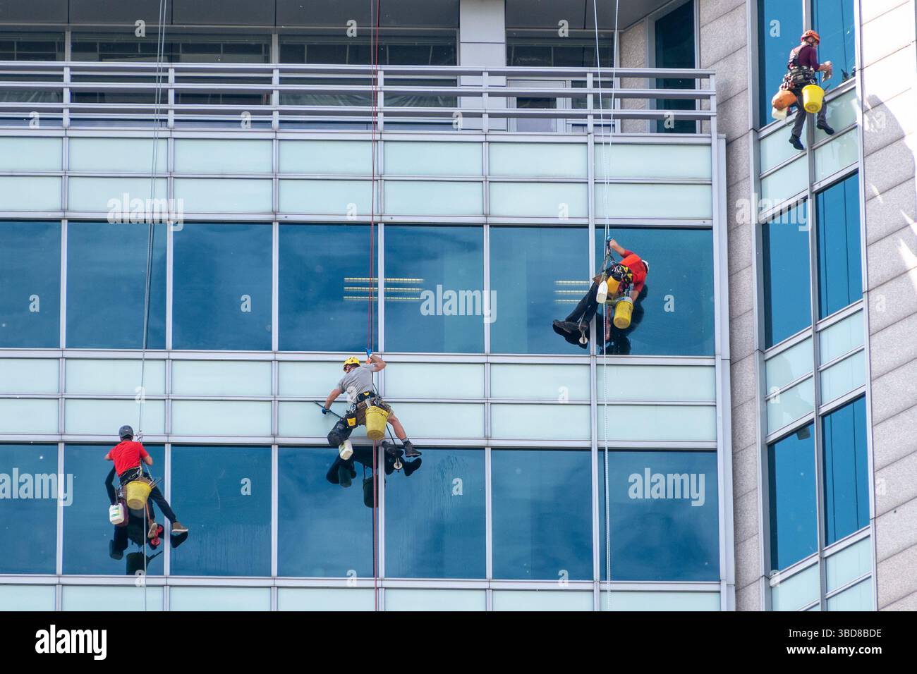 Window washers cleaning high-rise building exterior. Warsaw, Poland ...