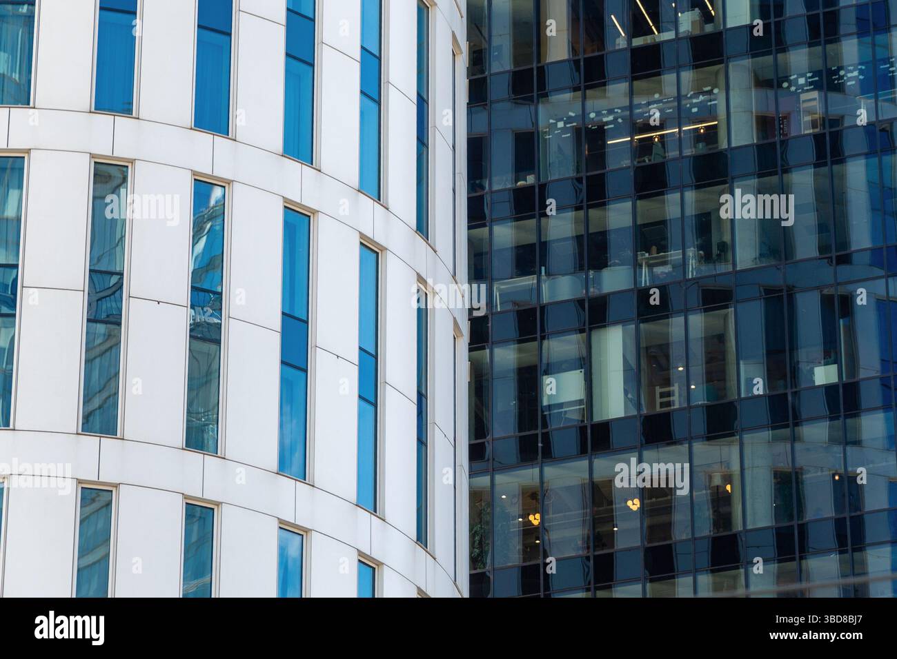Modern architectural contrast of adjacent office buildings with glass ...