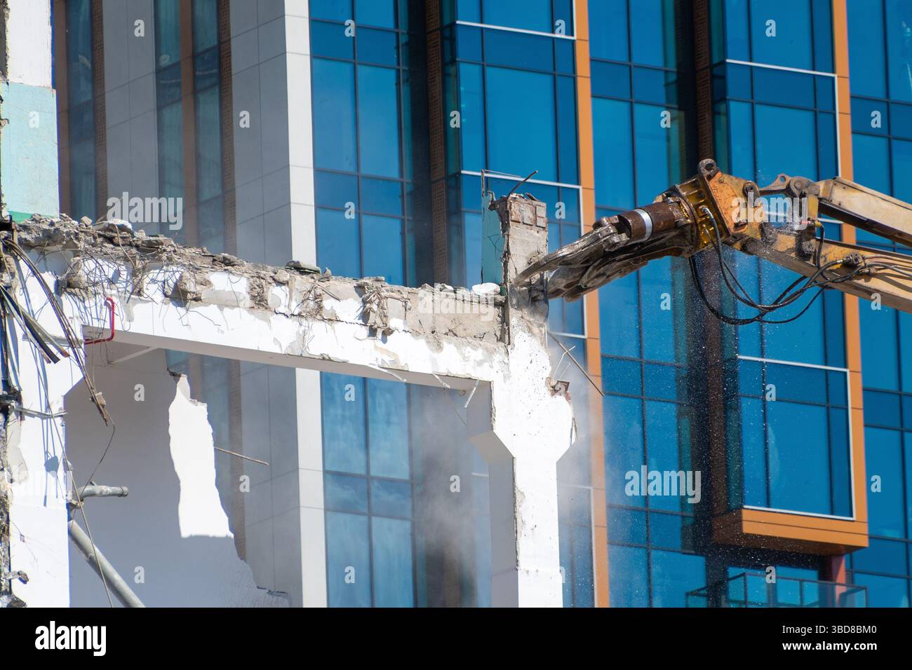 Building demolition with excavator arm in urban construction site Stock ...