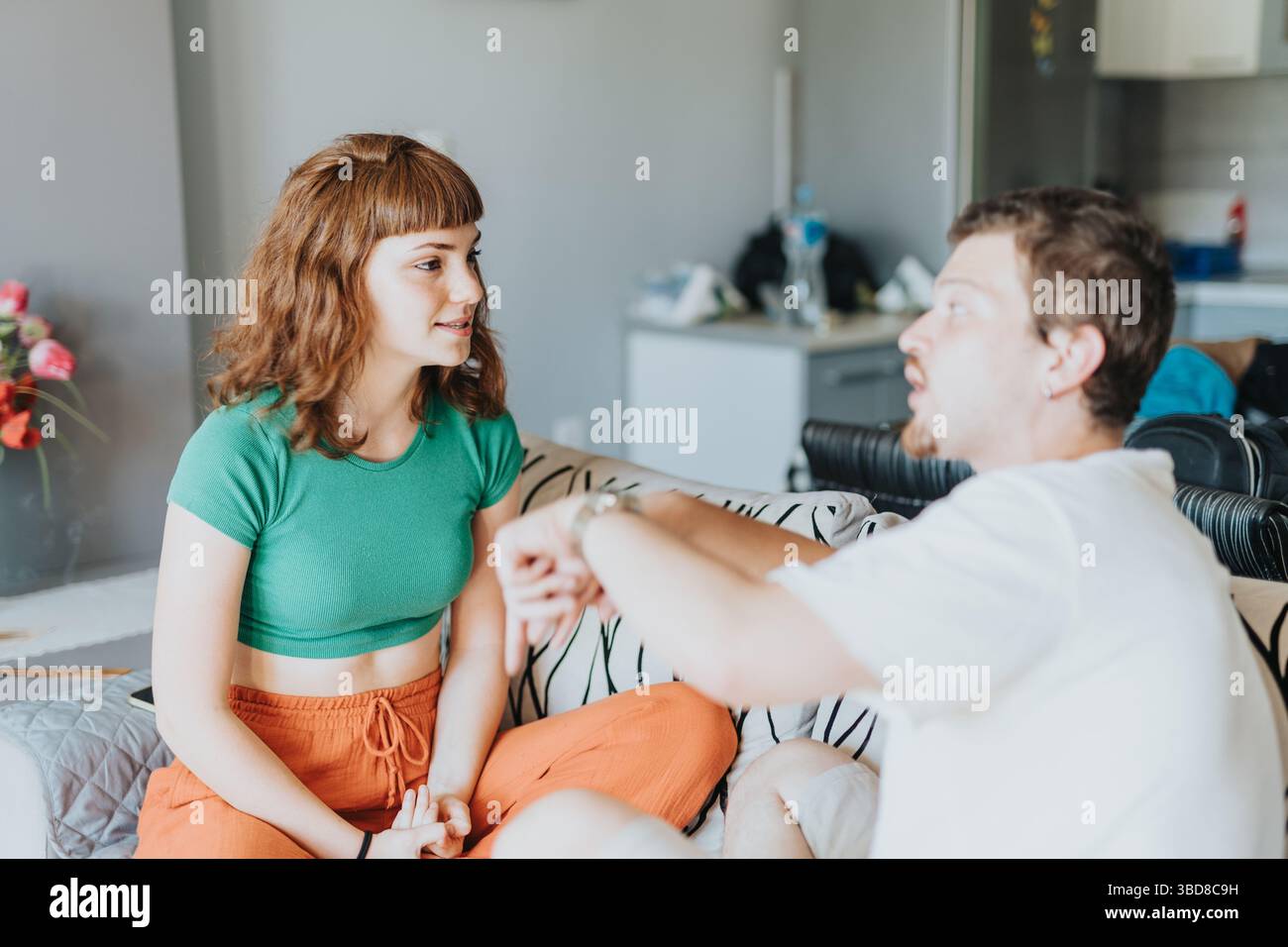 Friends having a casual and engaging conversation in a contemporary ...
