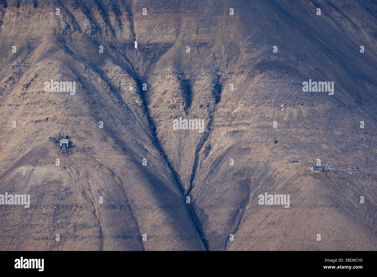 Derelict mining structures sit on an eroded Arctic slope in Svalbard ...