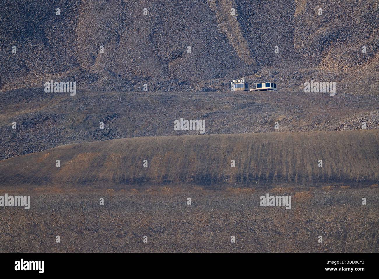 A remote monitoring or research station sits high on a barren Arctic ...