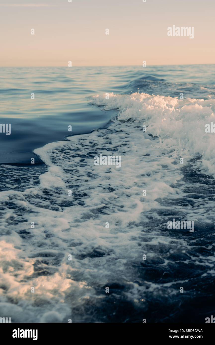 Sunset waves behind boat hi-res stock photography and images - Alamy