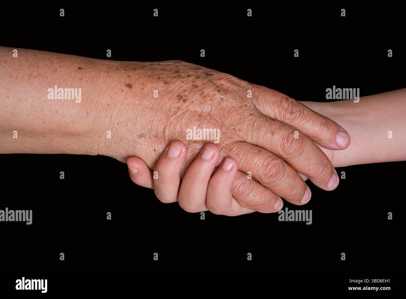 Close-up of young and elderly hands meeting in a gentle touch Stock ...