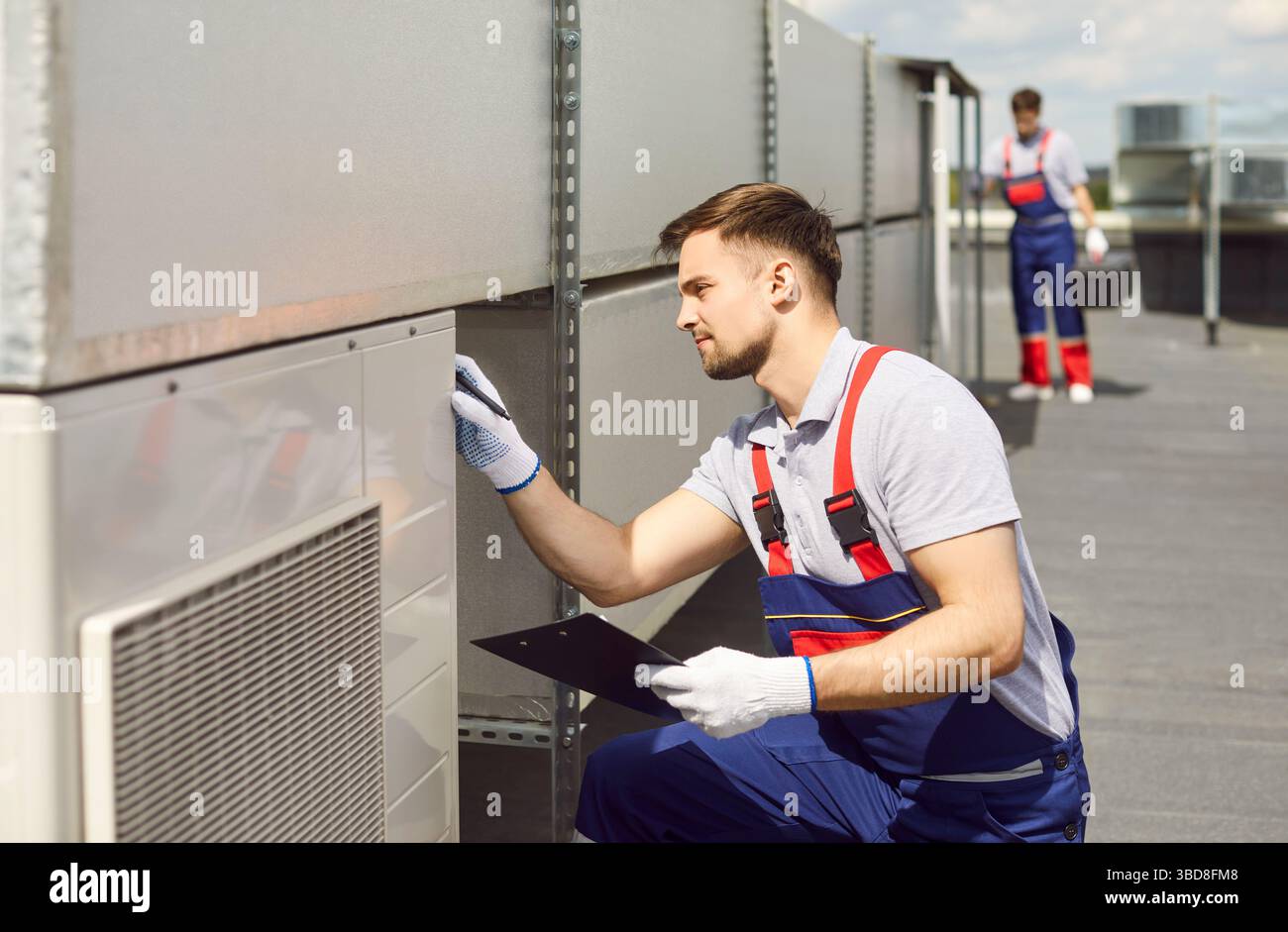 Worker Inspecting And Testing Hvac System On Roof Stock Photo - Alamy