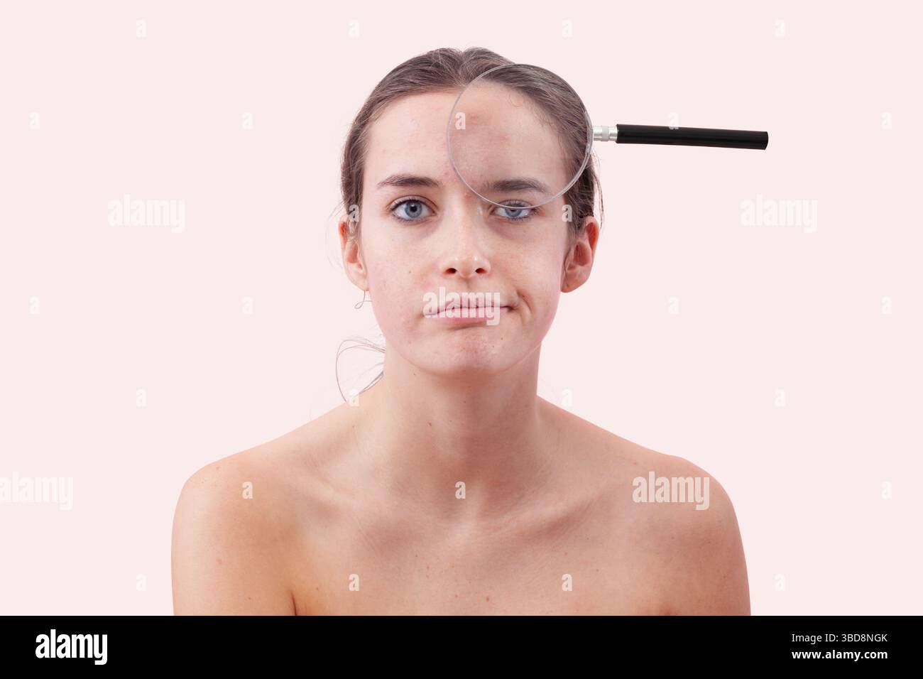 Annoyed young woman with no makeup, acne and blemishes under magnifying ...