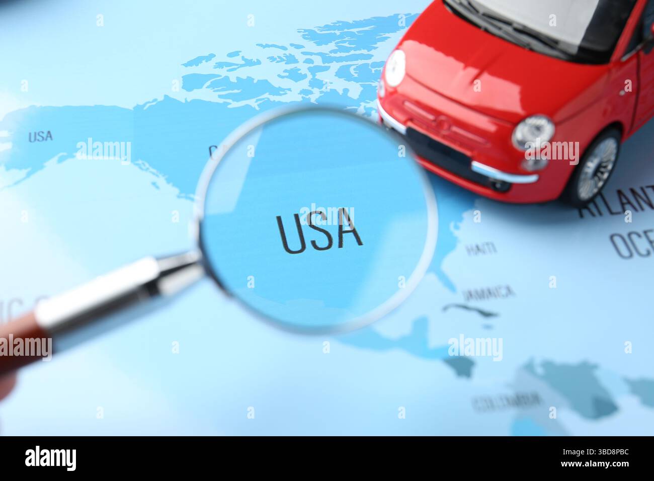 Looking at world map through magnifying glass and toy car, closeup ...