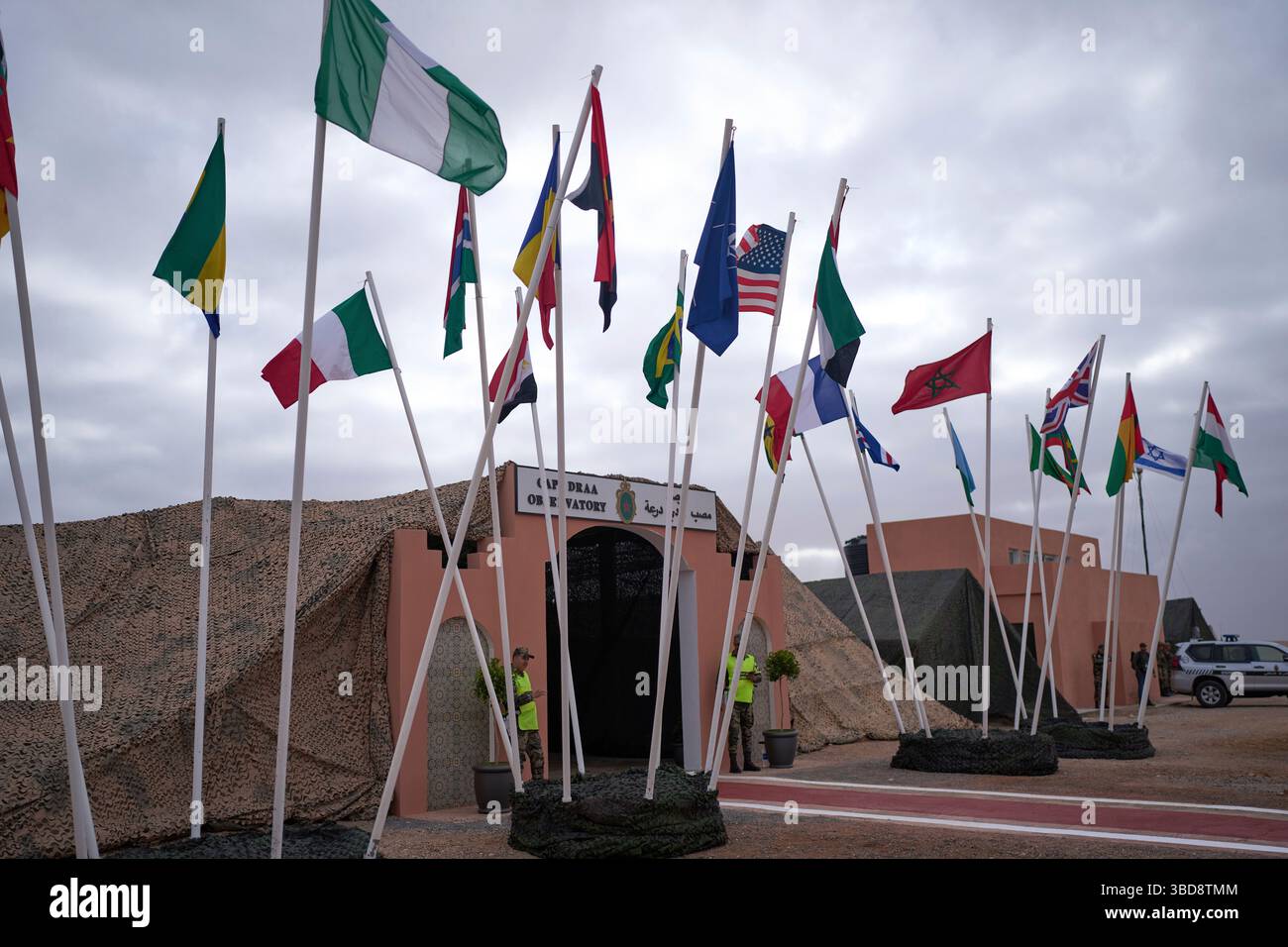 Flags of participating countries are placed outside an observatory ...