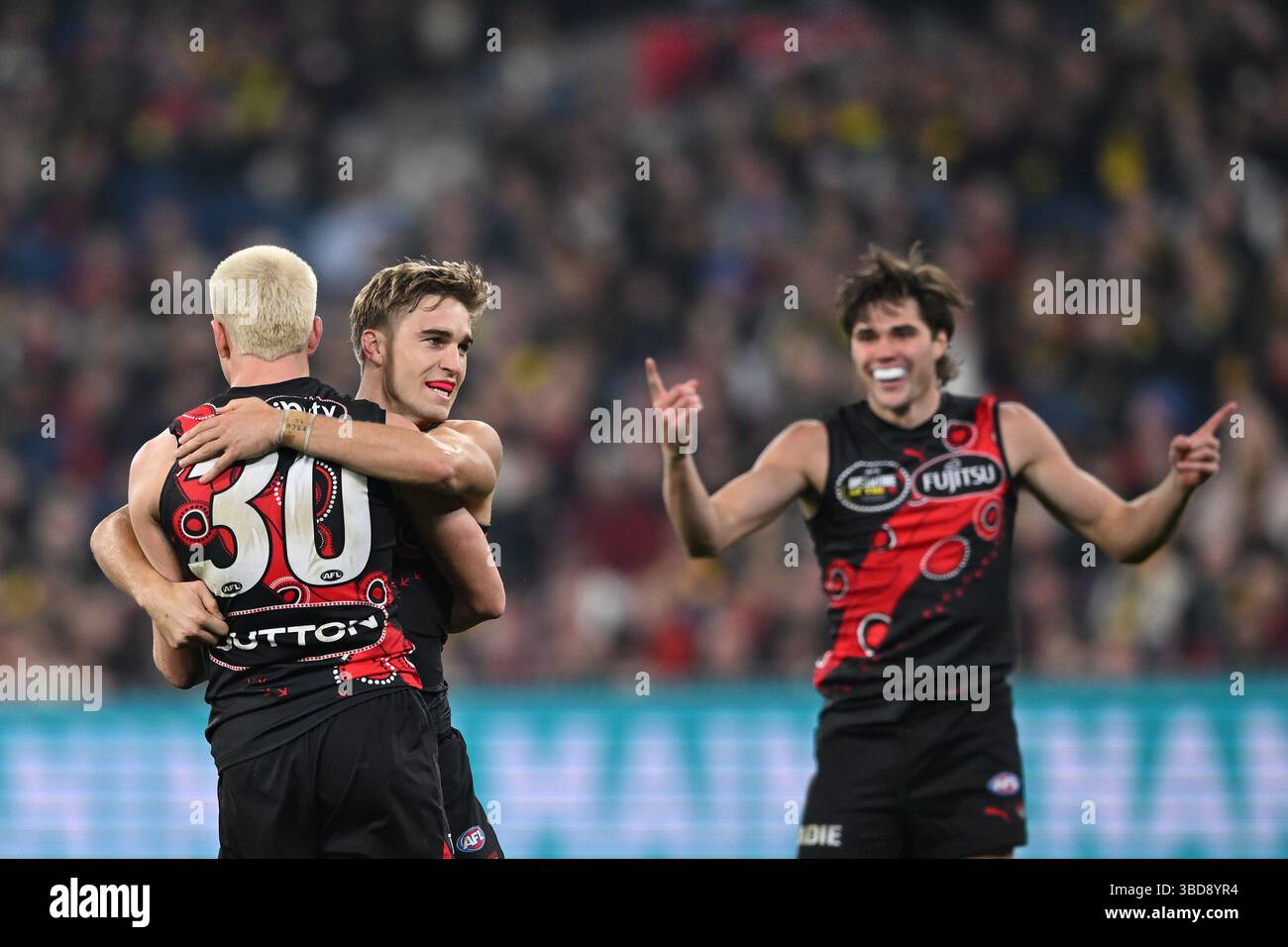 Melbourne, Australia. 23rd May, 2025. Matt Guelfi of Essendon (centre ...