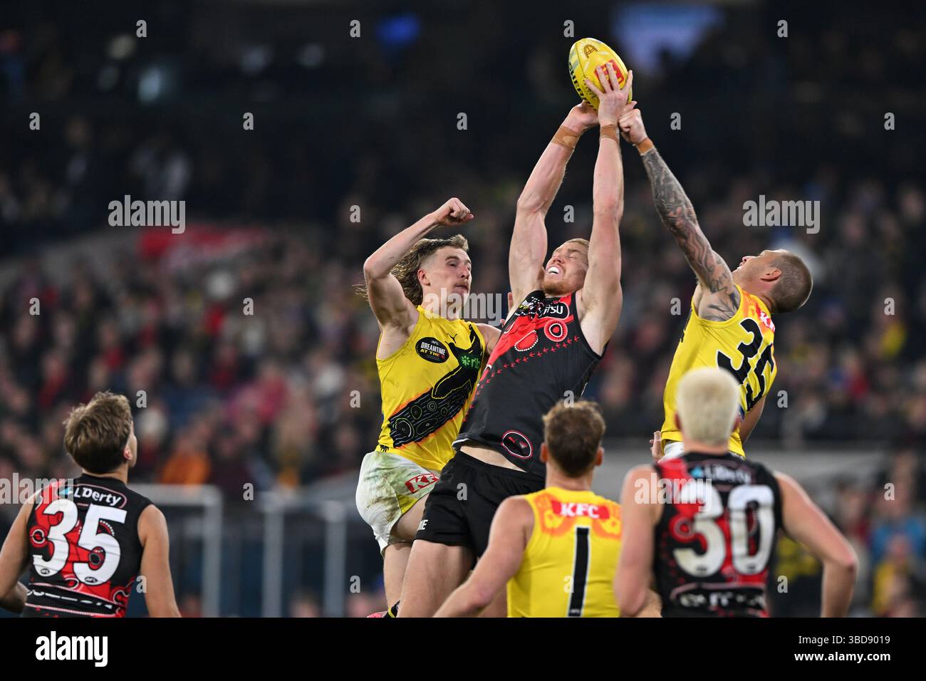 Melbourne, Australia. 23rd May, 2025. Peter Wright of Essendon (centre ...