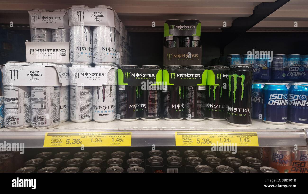 Aluminum cans of Monster energy drink on the store shelf,selective ...