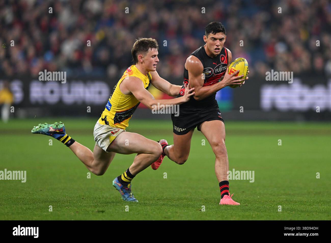 Melbourne, Australia. 23rd May, 2025. Sam Durham of Essendon (right) in ...