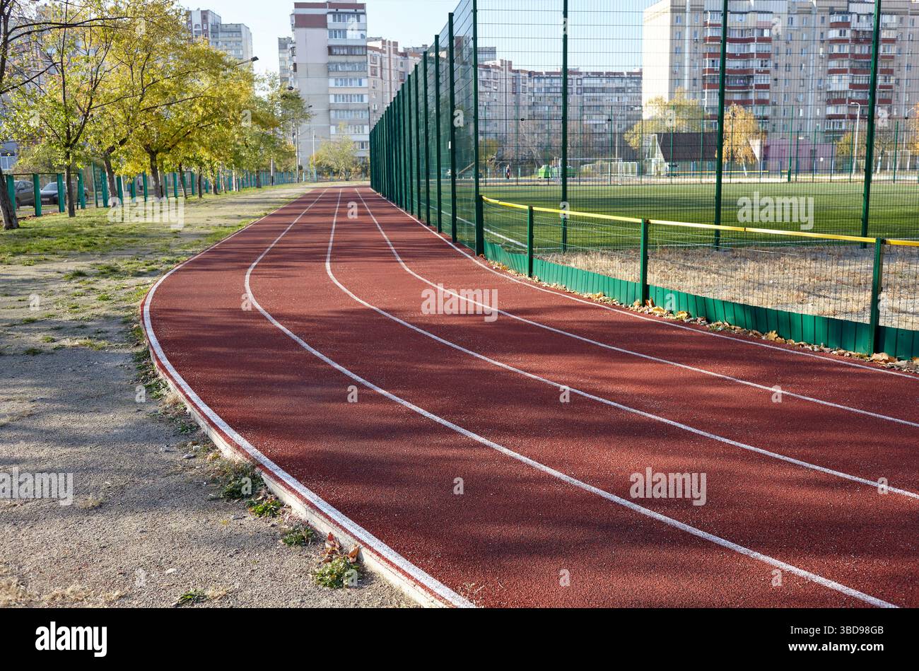 Red treadmill on sport field. Landscape of soccer field with green ...