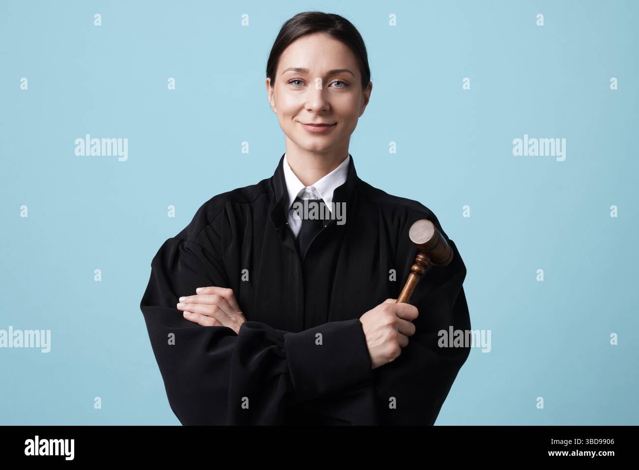 Judge with mallet on light blue background Stock Photo - Alamy