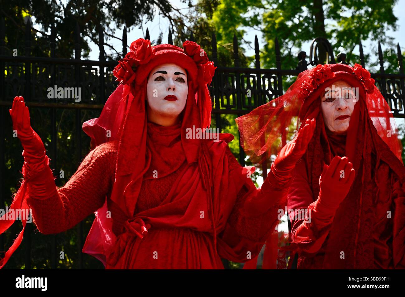The Red Rebel Brigade NL forms a silent protest during the 'draw the ...