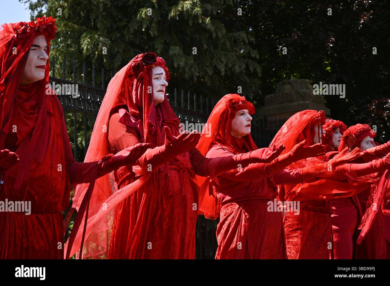 The Red Rebel Brigade NL forms a silent protest during the 'draw the ...