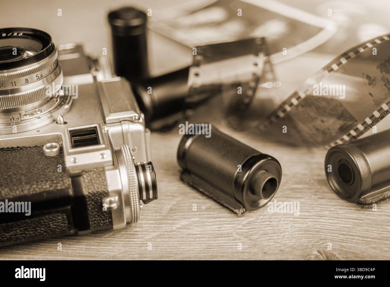 Close-up view of a vintage camera alongside film rolls and developed ...