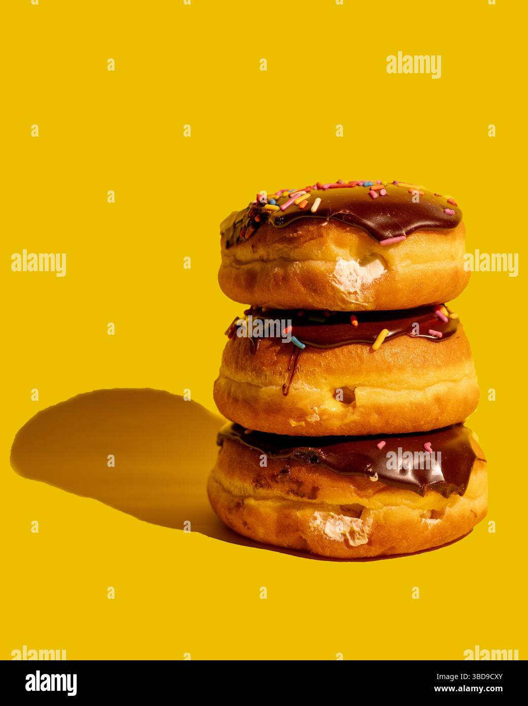 Three chocolate donuts stacked hi-res stock photography and images - Alamy