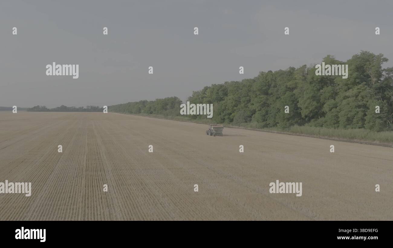 Aerial view of Farmer fertilizing agricultural field. Spreading mineral ...