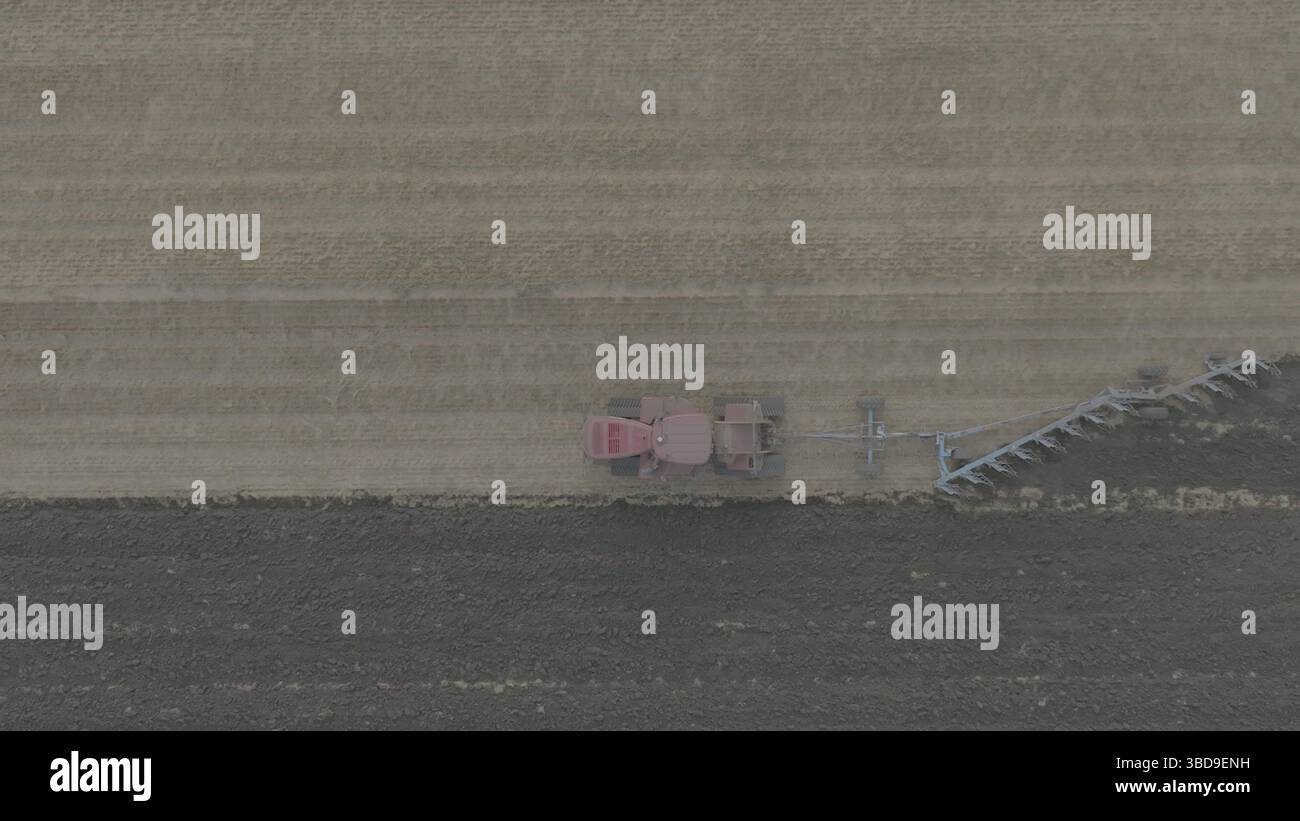 Big red tractor on on rubber tracks, Pulling productive reverse plow on ...