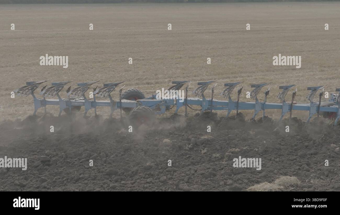 Big red tractor on on rubber tracks, Pulling productive reverse plow on ...