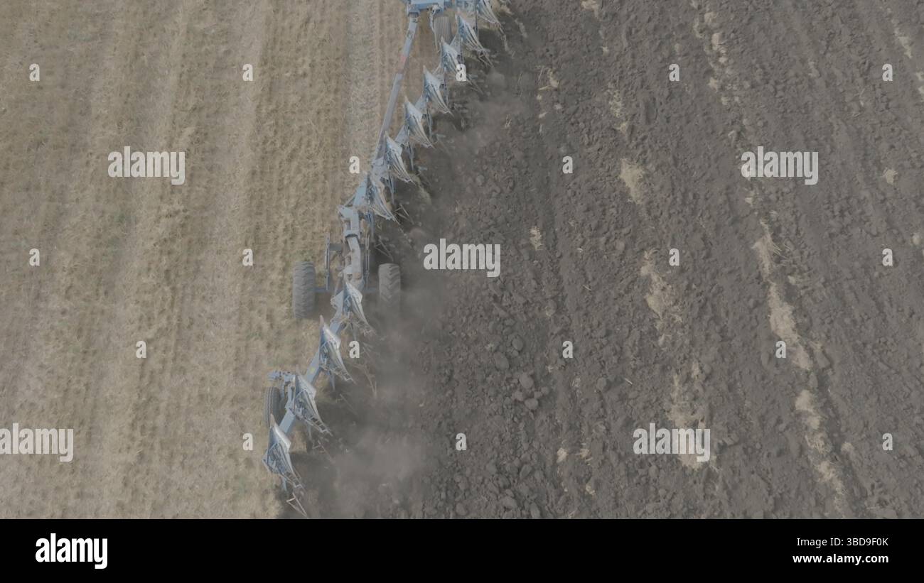 Big red tractor on on rubber tracks, Pulling productive reverse plow on ...