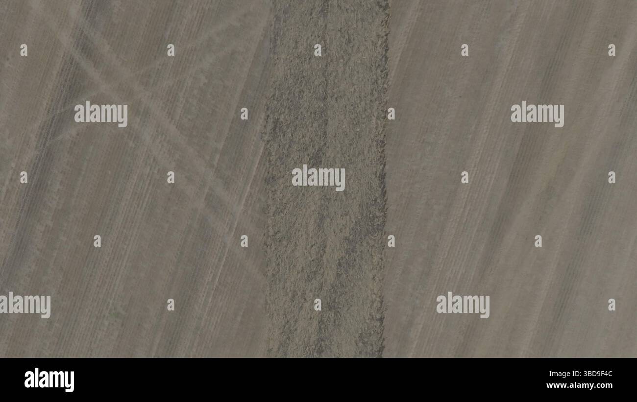 Disking the field. Tractor cultivating land of Disc Harrow, close up ...