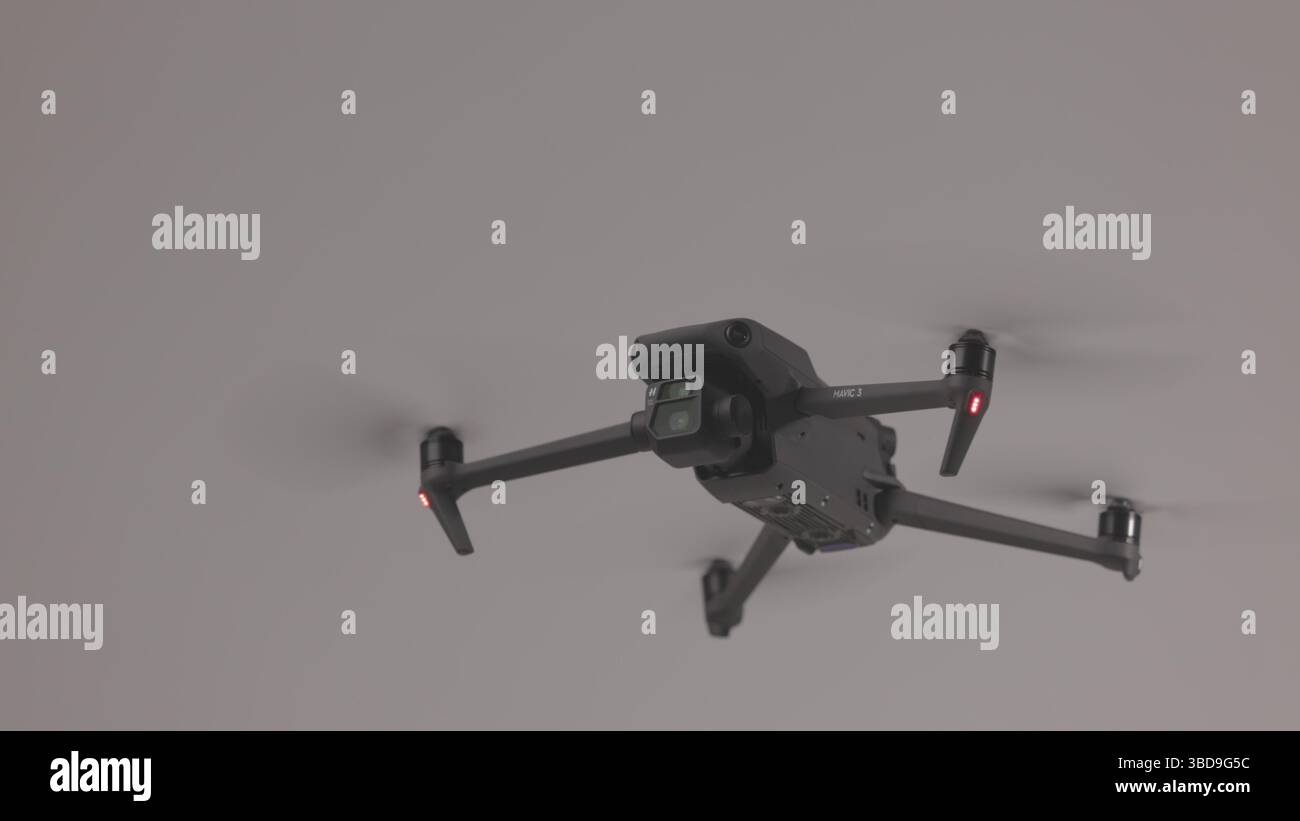 DJI Mavic 3 - Flying on white background. Most popular drones. Copter with propellers protection ...
