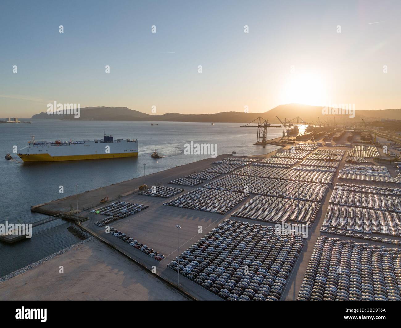 New Cars on Parking Lot and ro-ro Cargo Ship in Port of Setubal. Aerial ...
