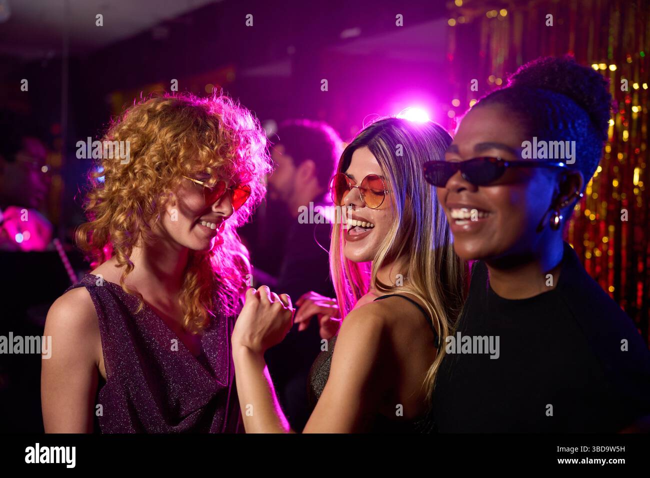 Happy multi-ethnic girlfriends dancing and enjoying night party at ...