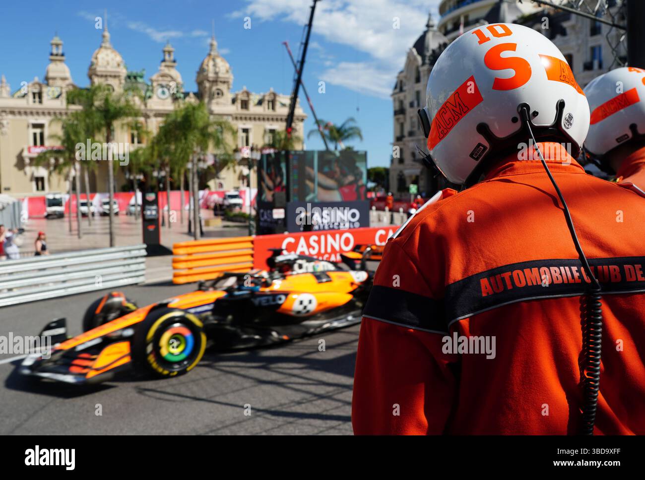 Track marshals watch McLaren's Oscar Piastri drive past during the ...