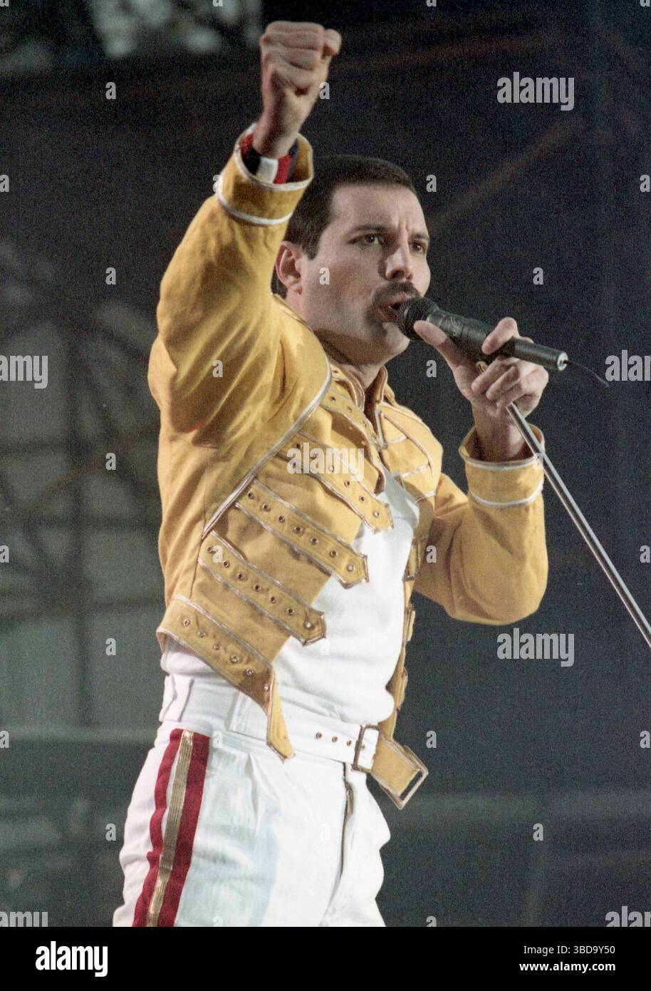 The lead singer of the band Queen, Freddie Mercury, singing during an ...