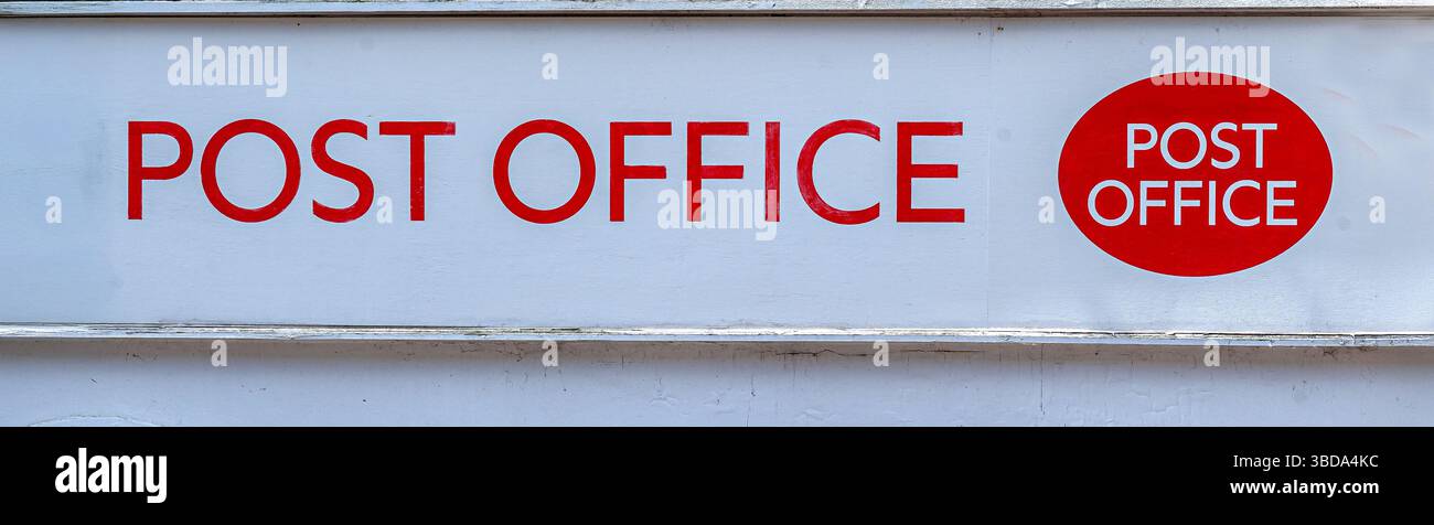 A simple post office sign of red lettering on a white background and a ...
